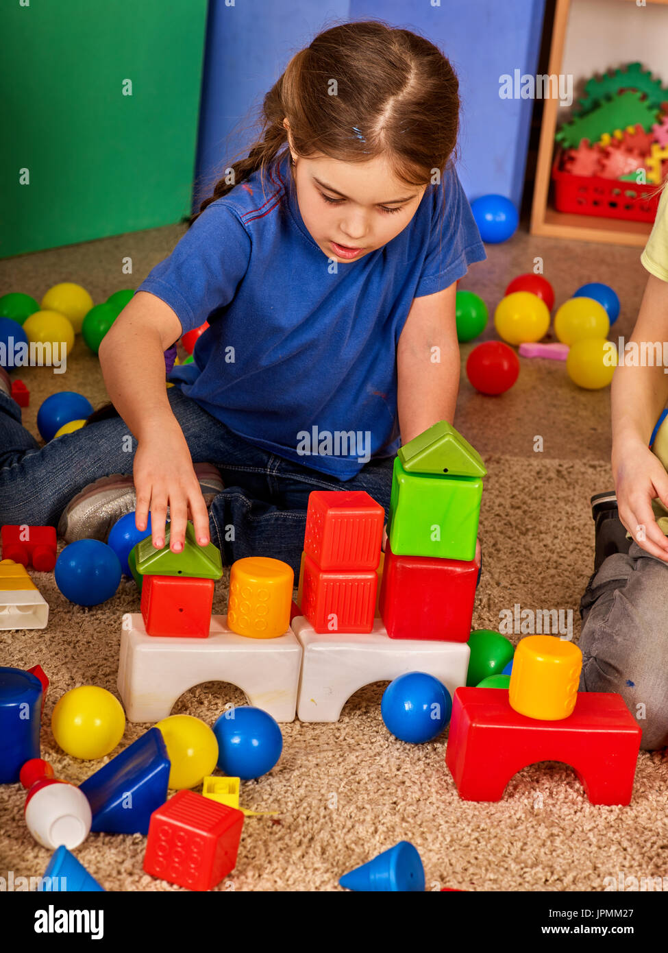 Children building blocks in kindergarten. Group kids playing toy floor ...
