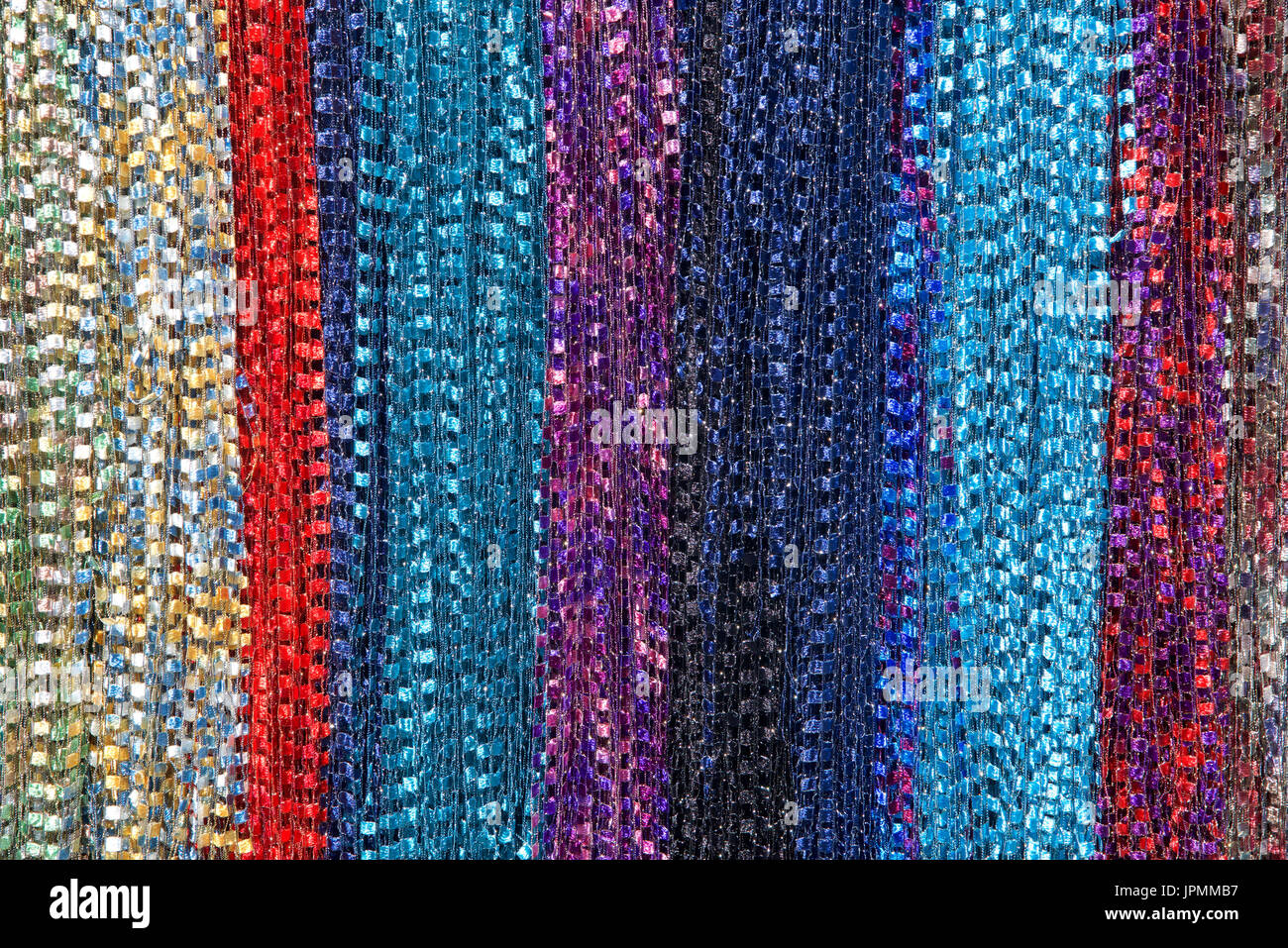Background fabric strings creating scarfs, multiple colored scarves ...