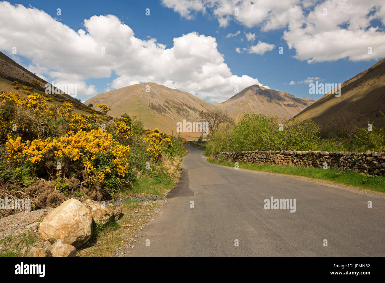 Landscape in Lake District National Park with narrow road passing ...