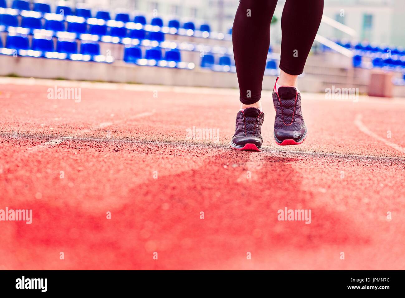 Runner feet running on stadium track closeup - woman running concept ...