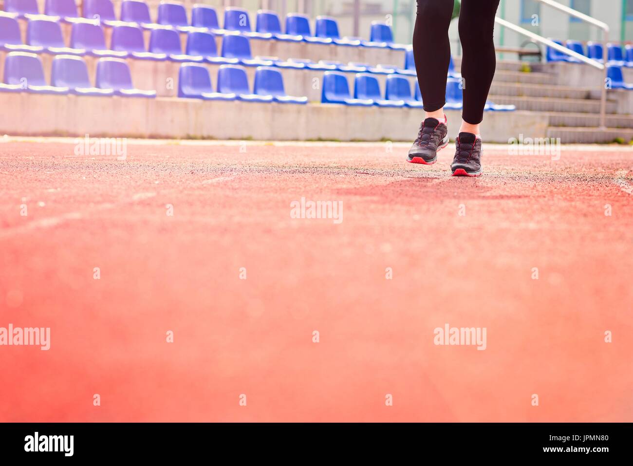 Runner feet running on stadium track closeup - woman running concept ...