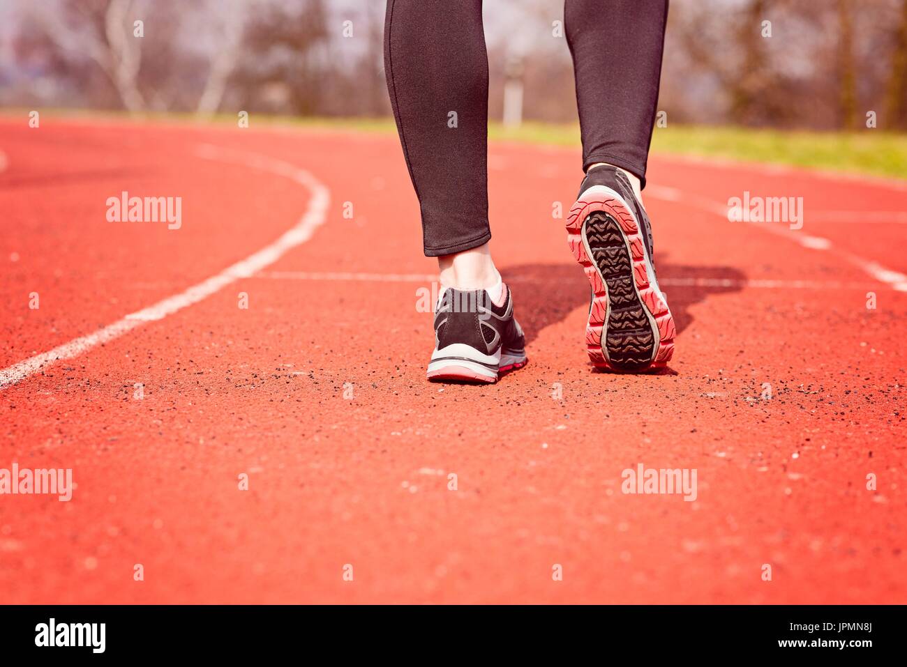 Runner feet running on stadium track closeup - woman running concept ...