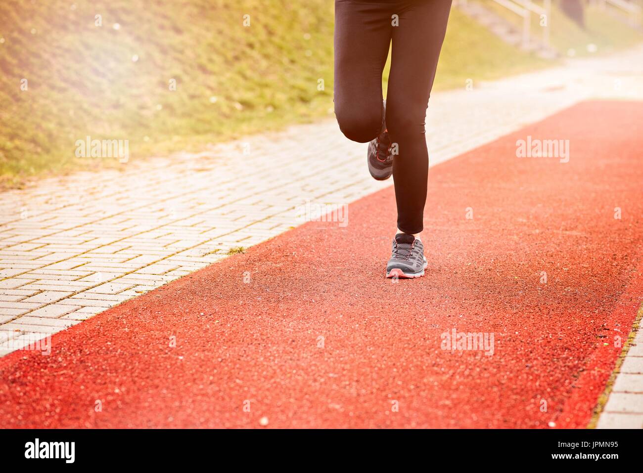 Runner feet running on stadium track closeup - woman running concept ...