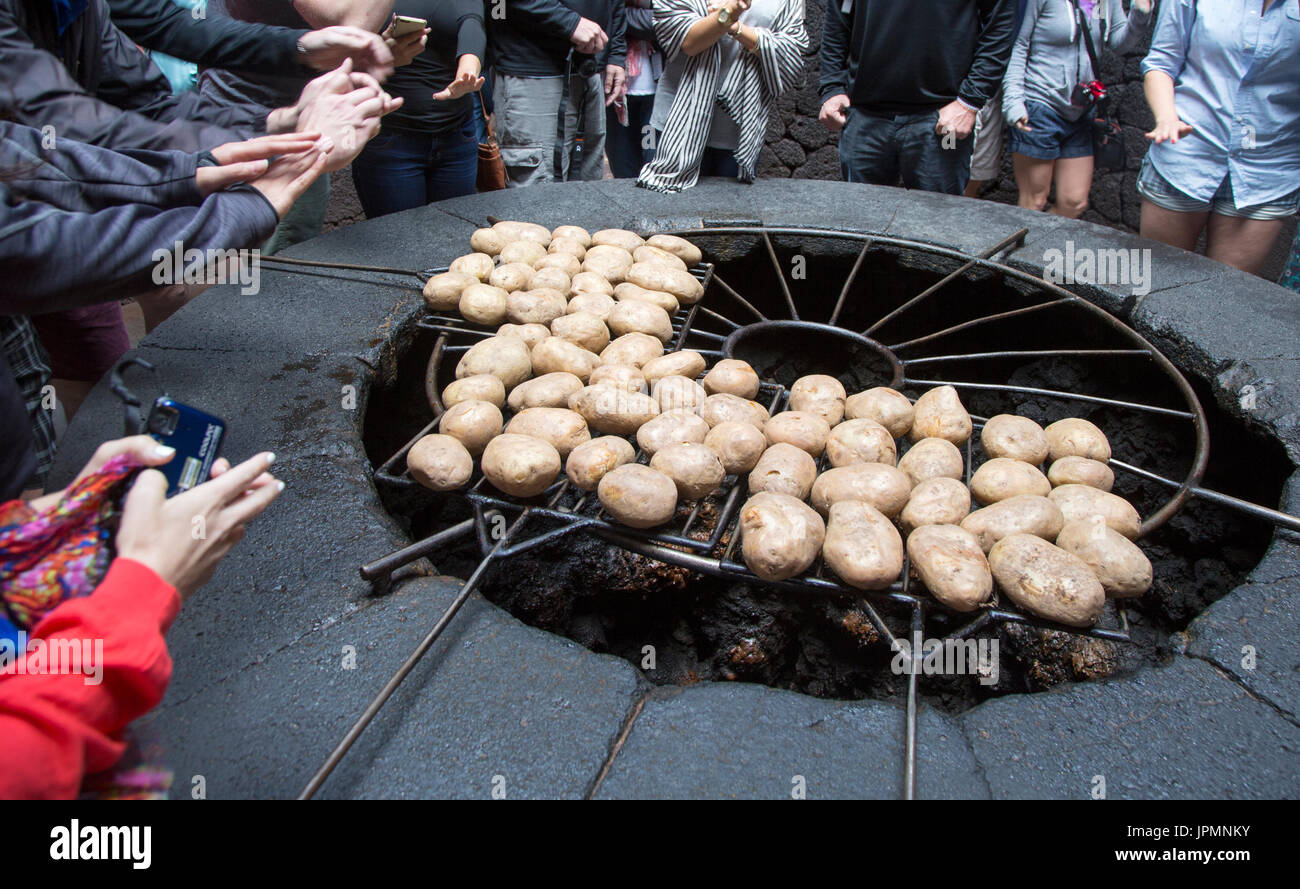 Food being cooked on volcanic grill at visitor centre, Parque Nacional ...