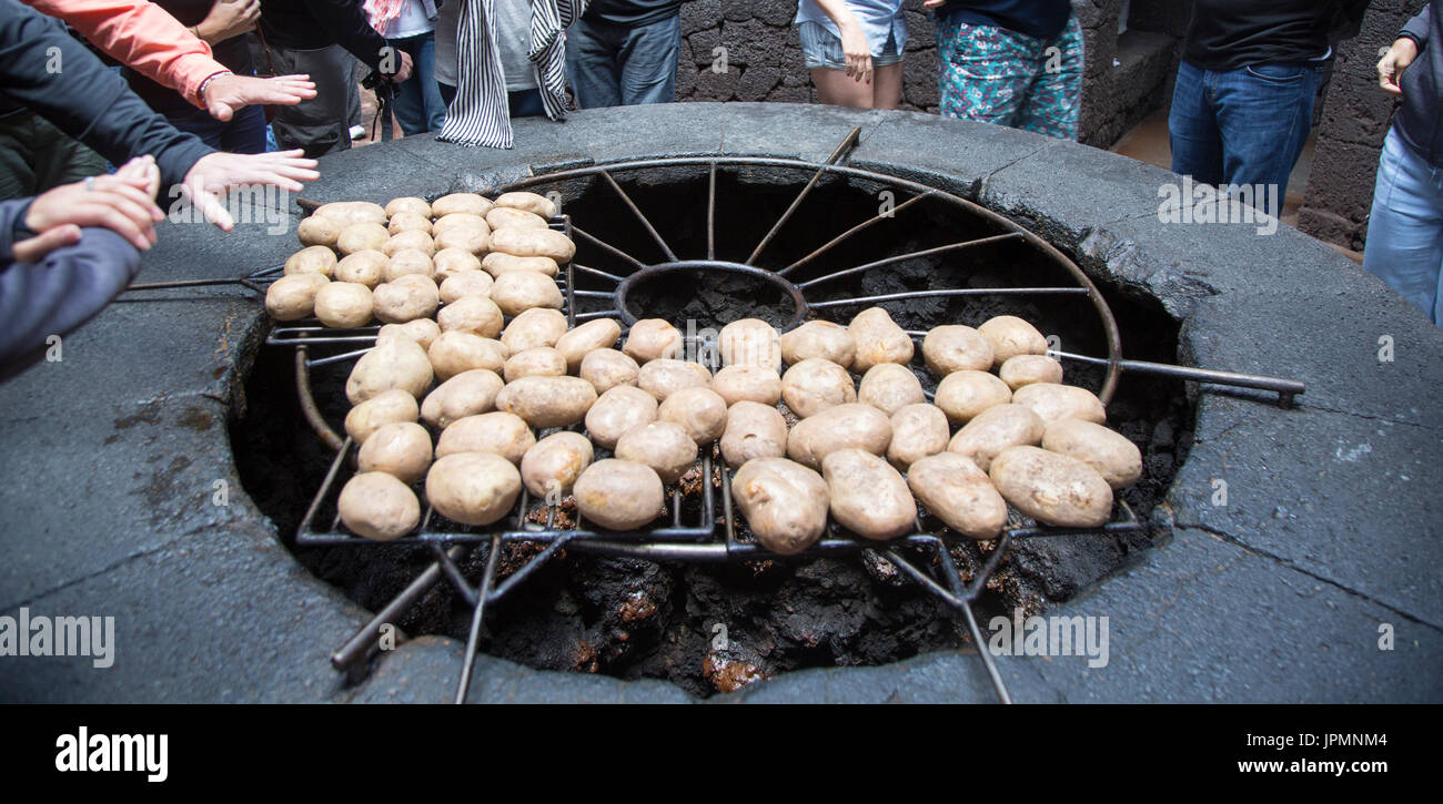 Food being cooked on volcanic grill at visitor centre, Parque Nacional ...