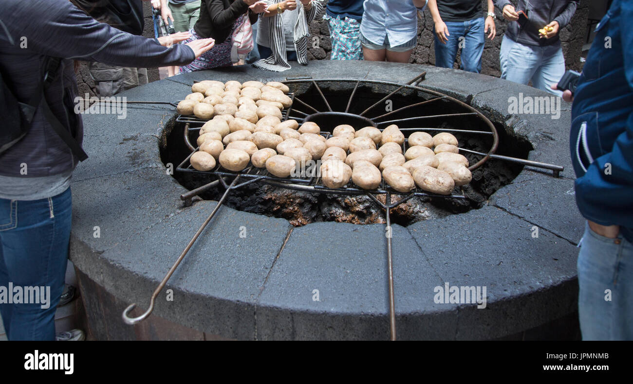 Food being cooked on volcanic grill at visitor centre, Parque Nacional ...