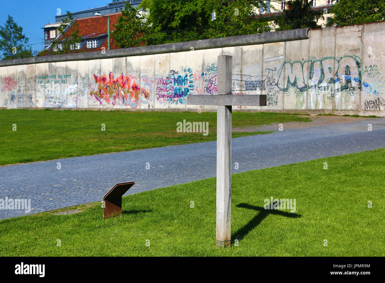Wooden cross and preserved sections of the Berlin Wall at the Berlin ...