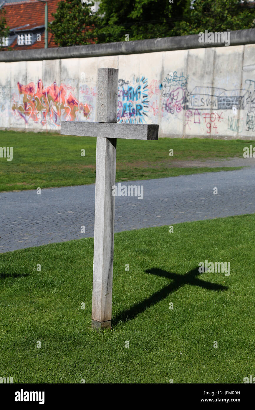 Wooden cross and preserved sections of the Berlin Wall at the Berlin ...