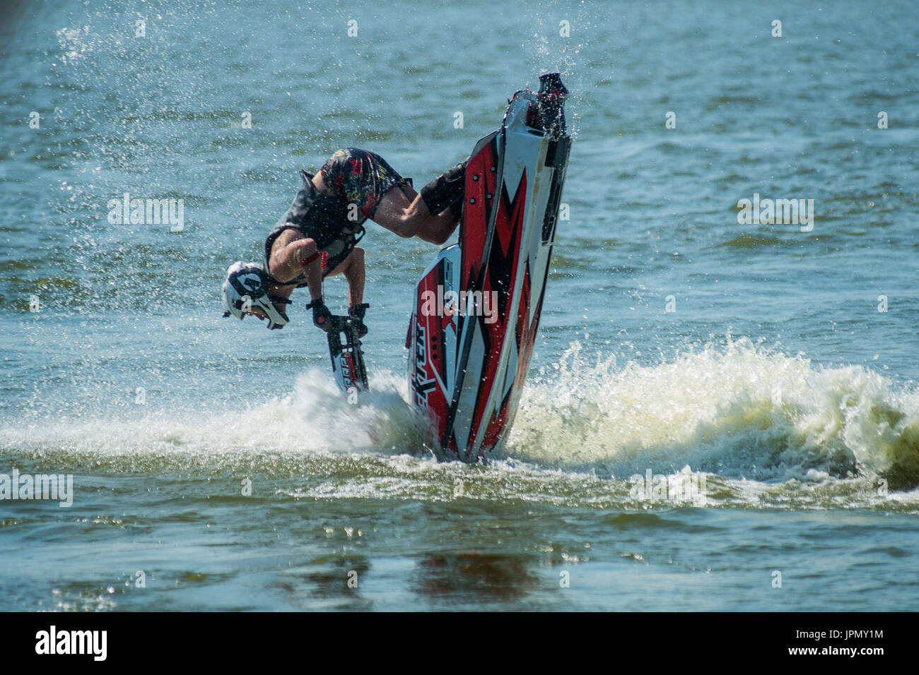 Man on jet ski turns with much splashes Stock Photo - Alamy