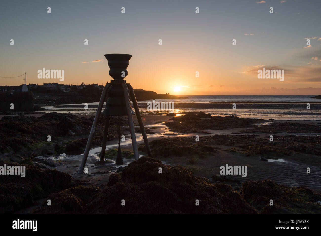 Sunset at The Time and Tide Bell (St Patrick's Bell) on the beach in ...