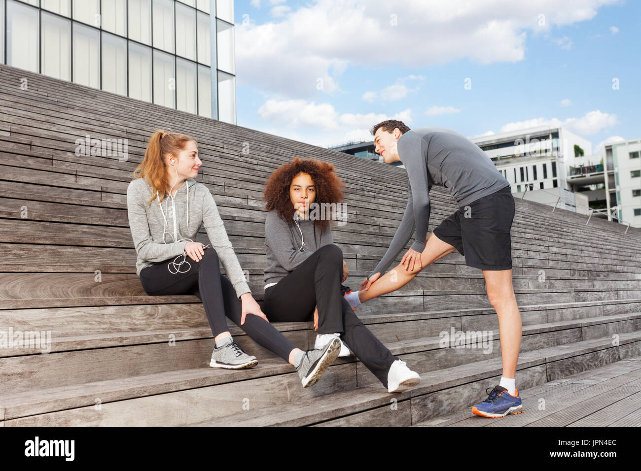 Young sporty people warming-up before training Stock Photo - Alamy