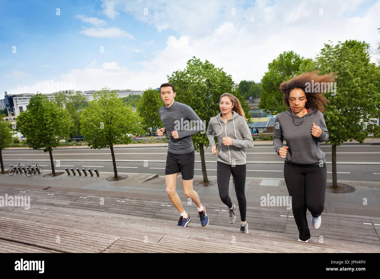 Young people running upstairs on city stairs Stock Photo - Alamy