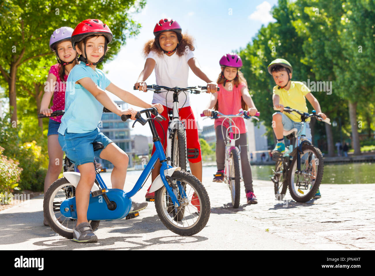 Children riding bicycles during summer vacation Stock Photo - Alamy