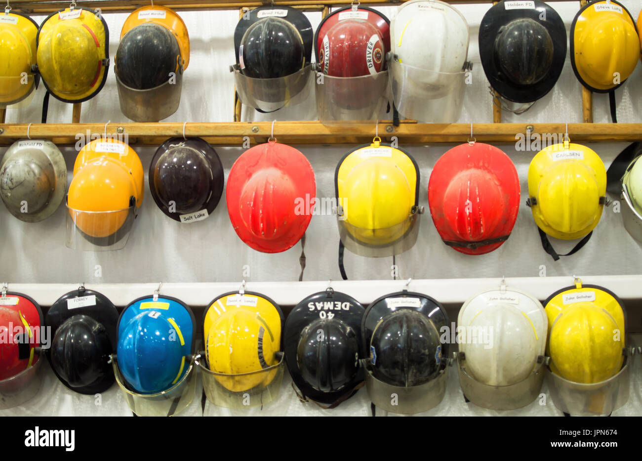 A row of firefighter helmets on display at firefighters museum Stock ...