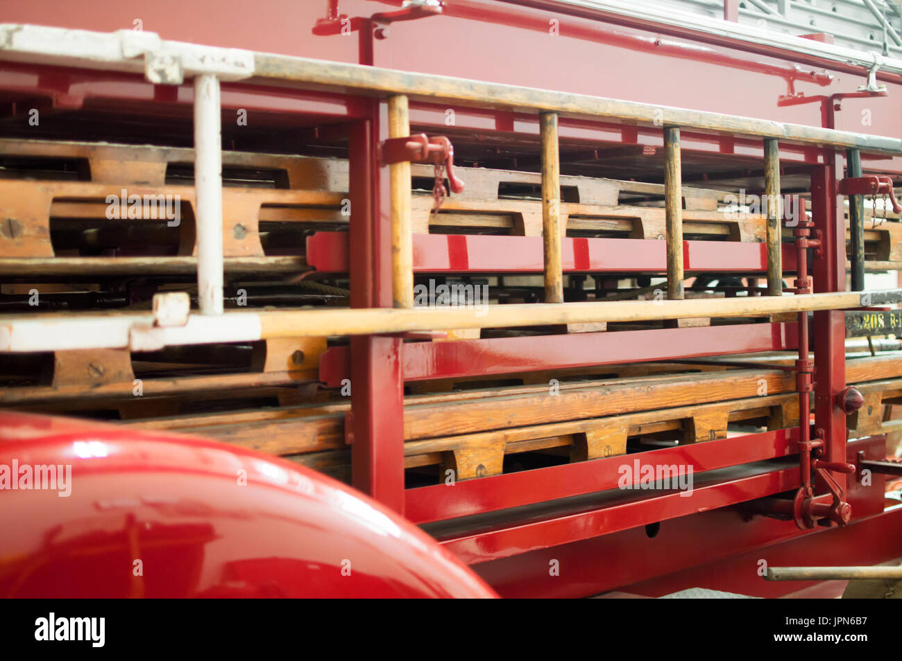 A vintage firetruck loaded with wooden extending ladders Stock Photo ...