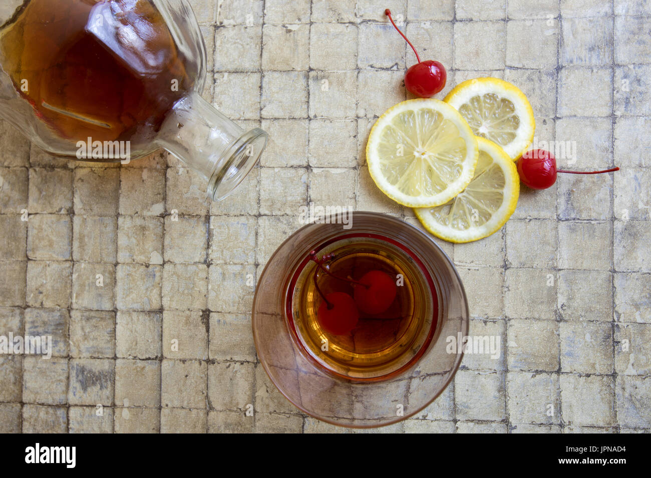 Flat lay classic Whisky Sour cocktail with lemon slices and cherries ...