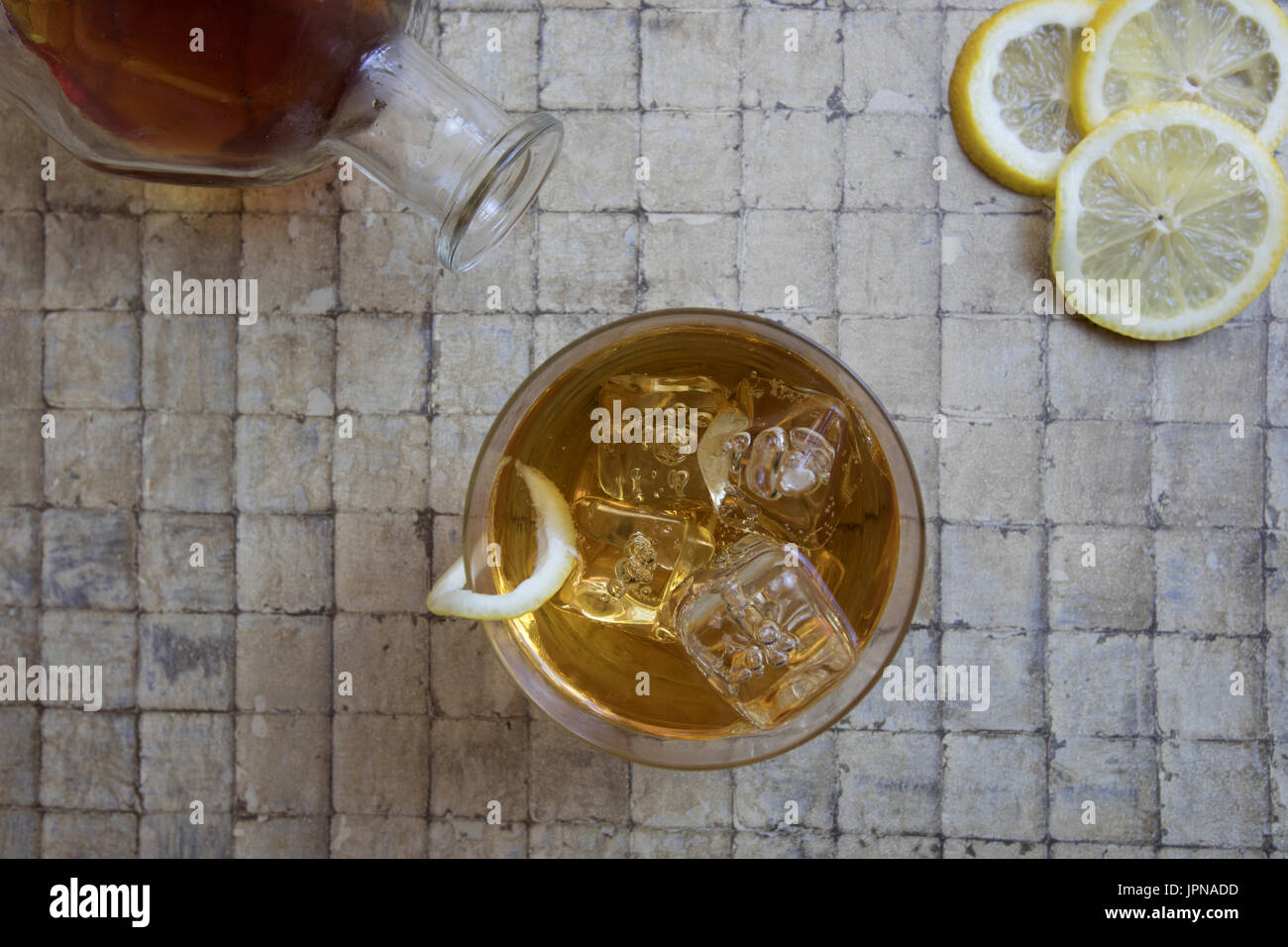 Classic Side Car cocktail garnished with lemon twist over ice with ...