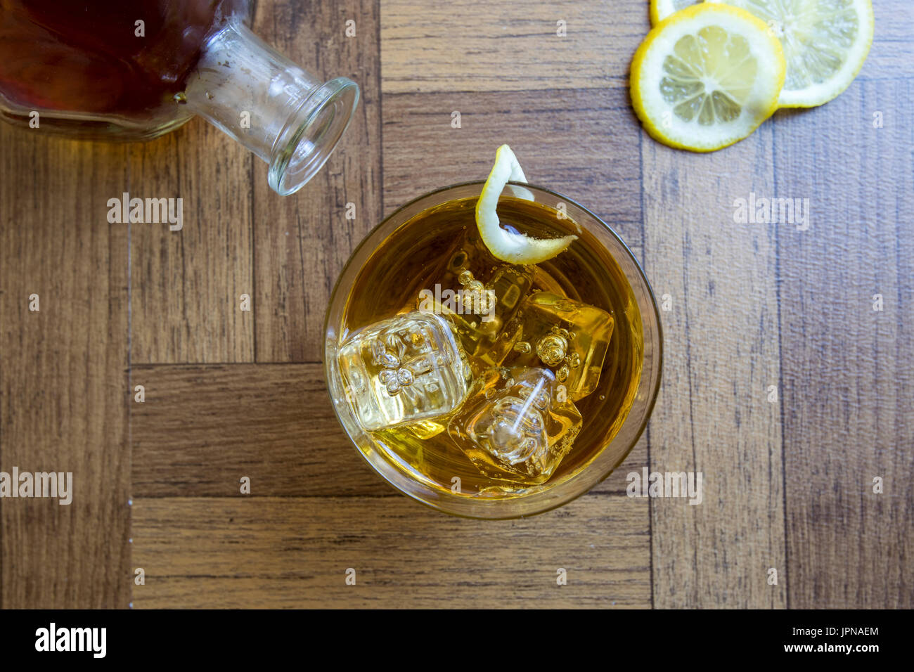 Classic Side Car cocktail garnished with lemon twist over ice with ...