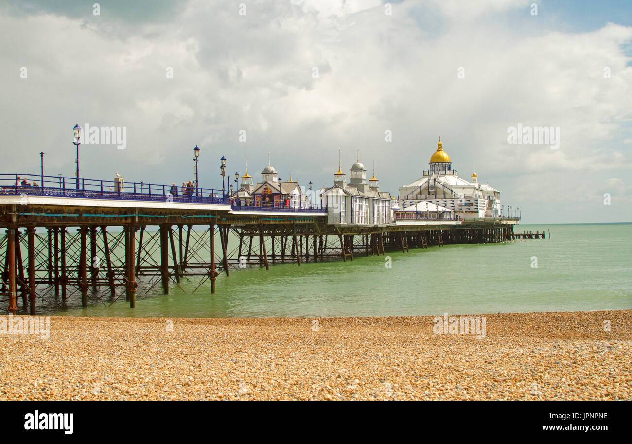 Beach and historic pier at British coastal holiday destination ...
