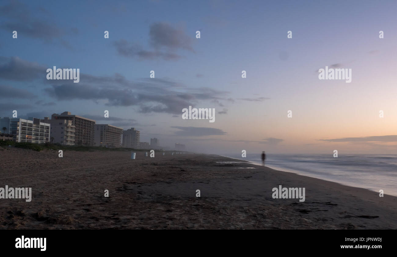 View of Man Walking on the Beach By Ocean Front Property Stock Photo ...