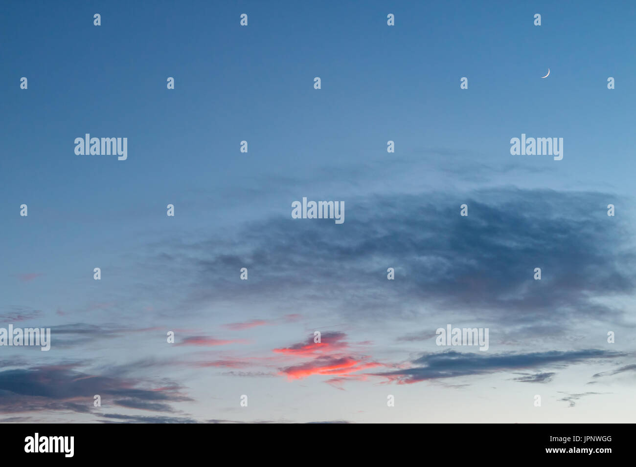 View of Sunset Clouds with Moon on the side Stock Photo - Alamy