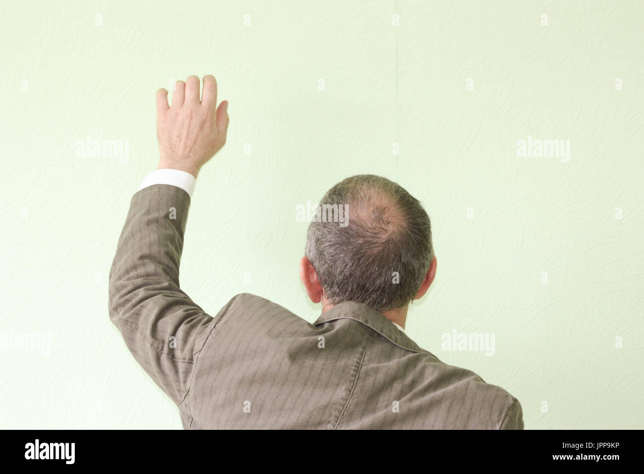 Business concept to go to higher goals. Man's back. Hand raised. Photo ...