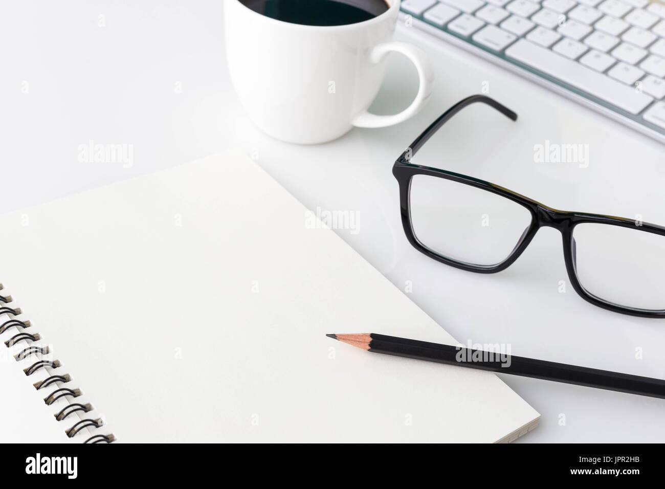 Modern white office desk top table with computer laptop, notebook and ...