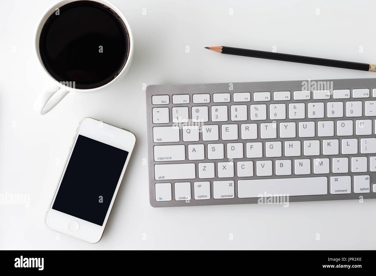 Modern white office desk top table with a cup of coffee, computer ...