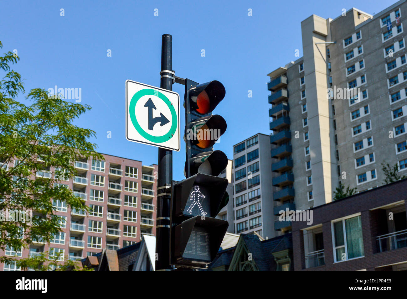 Traffic light in Montreal downtown among the skyscrapers. White ...