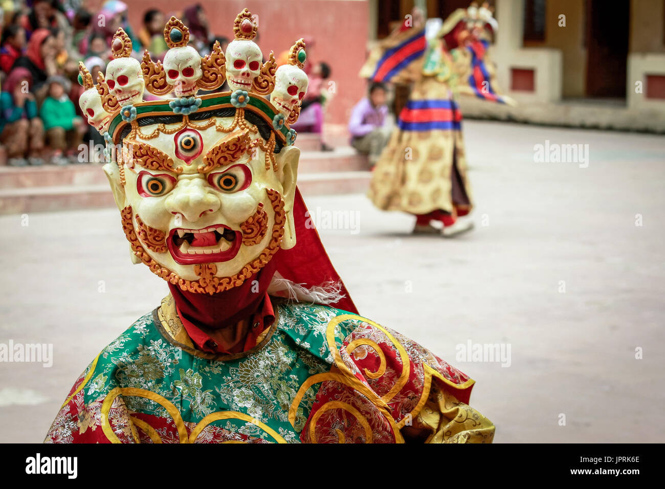 Tibetan Cham Dance performer wearing a scary mask which represents one ...