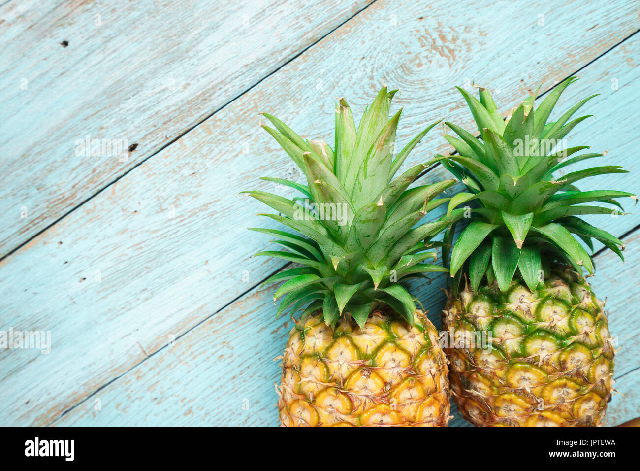 pineapple on the blue wood texture background. copy space Stock Photo ...
