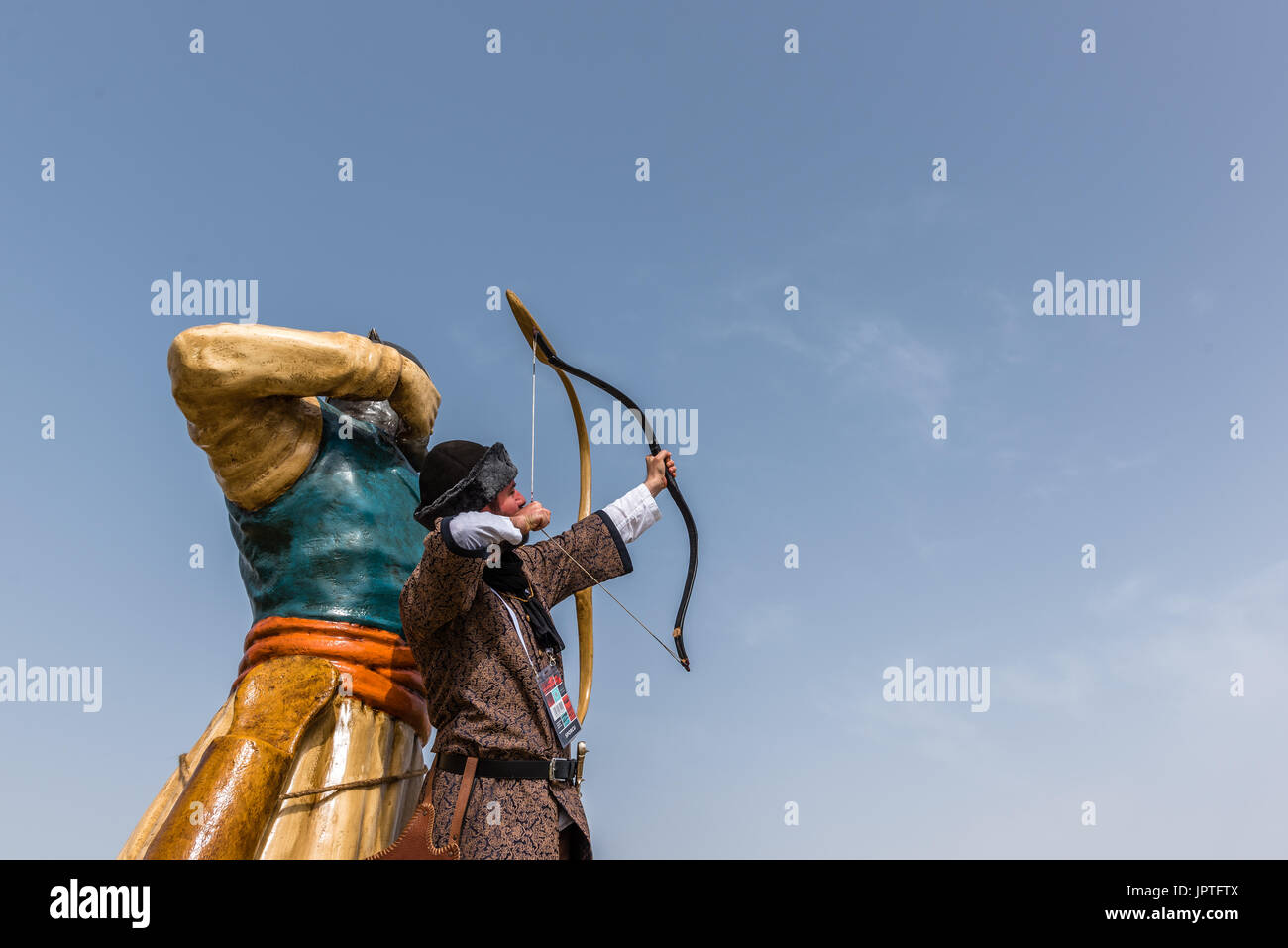 Statue of man archer and Unidentified medieval archer in costumes of ...