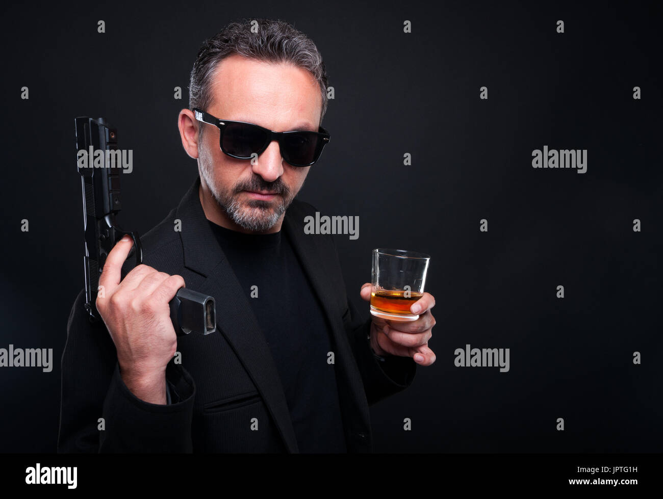 Thief gang member holding handgun hi-res stock photography and images ...