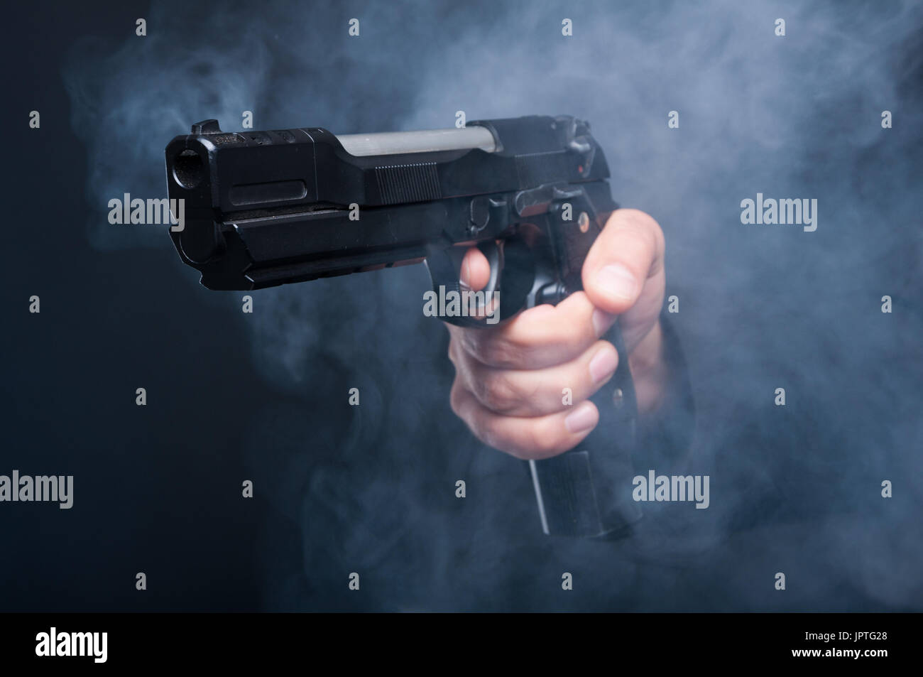 Closeup of gun in boss mafia hand on black background Stock Photo - Alamy