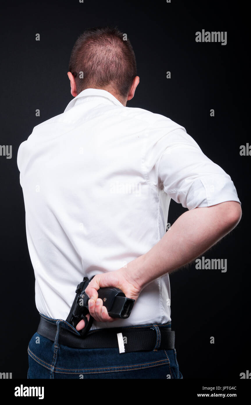 Gun hidden behind back hi-res stock photography and images - Alamy