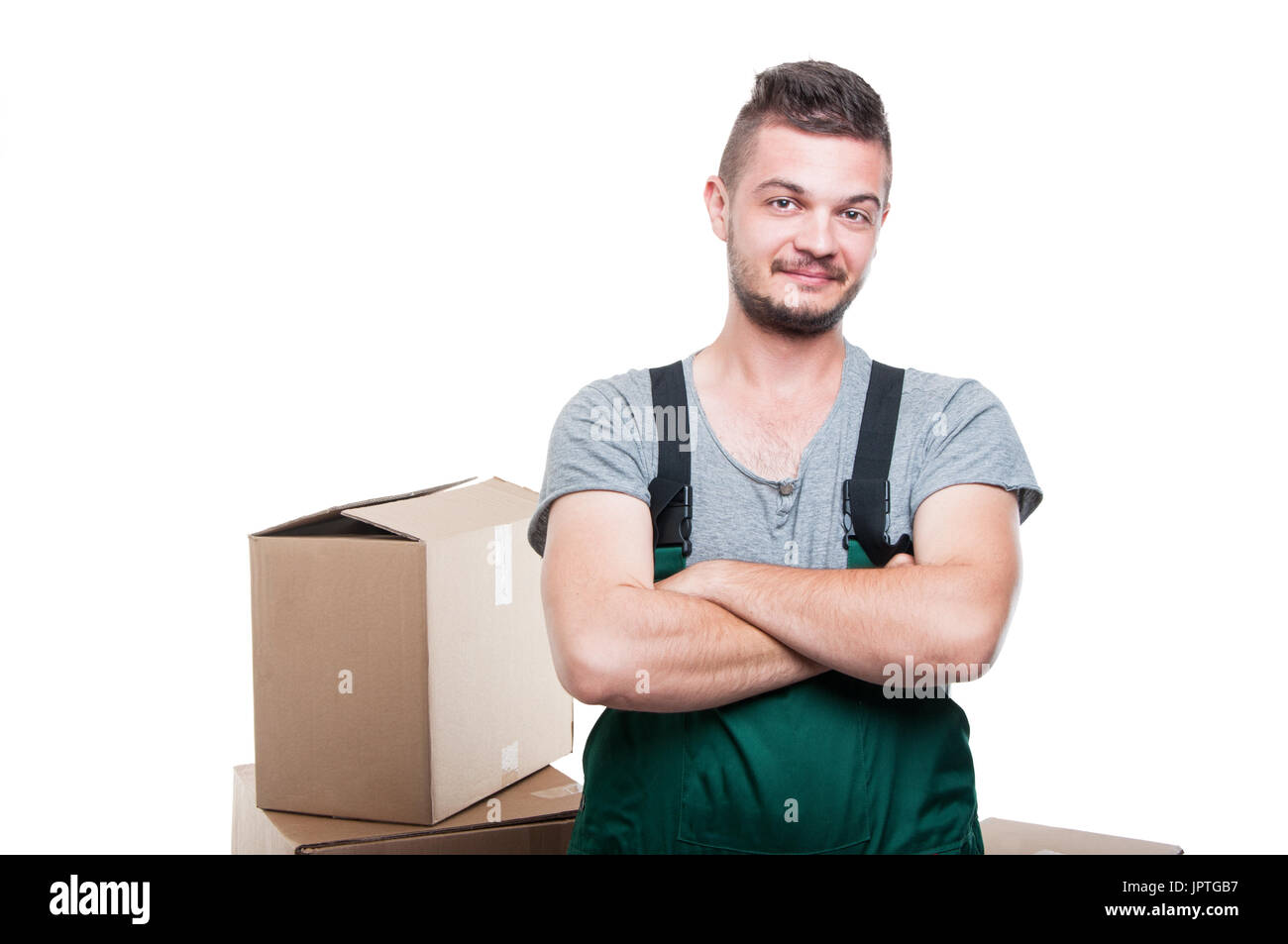 Handsome smiling mover guy posing with arms crossed and cardboard boxes ...