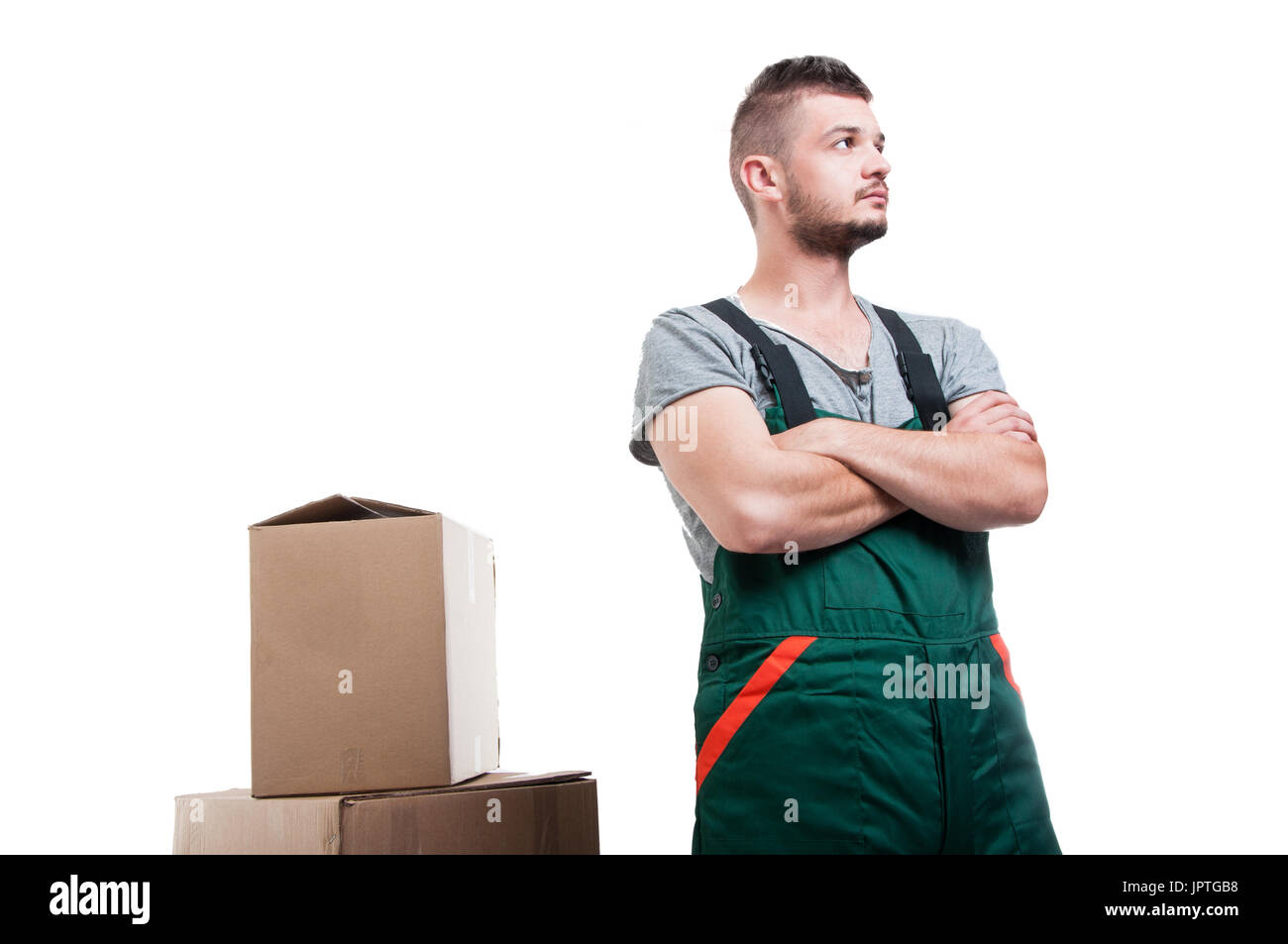 Low angle of mover guy posing with arms crossed and cardboard boxes ...