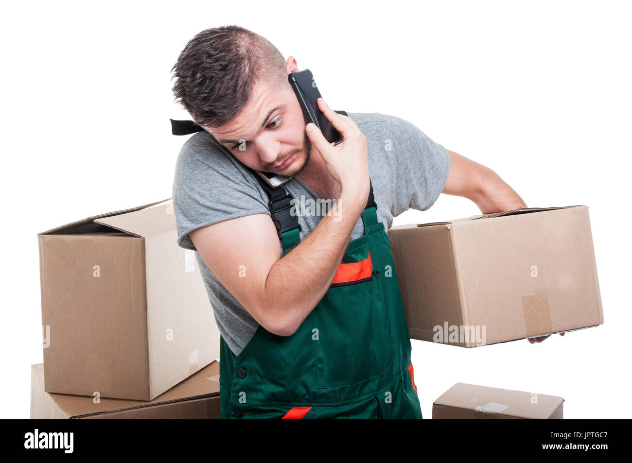 Mover guy holding cardboard box talking at phone looking very busy ...
