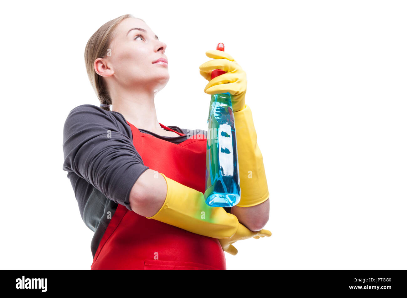Low angle shot of female housekeeper using spray to clean the house ...