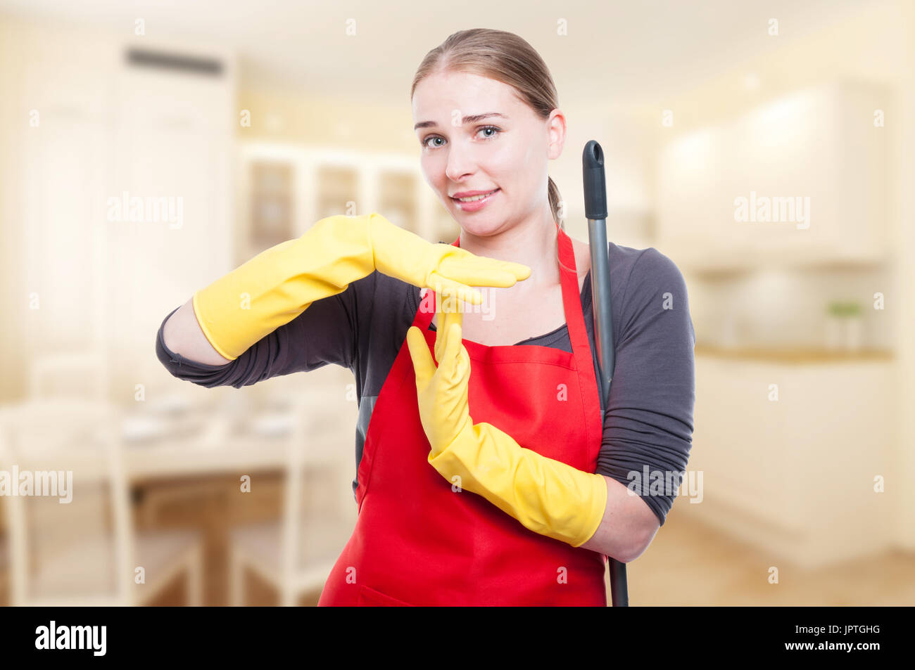 Female maid taking a break from cleaning the house and showing timeout ...