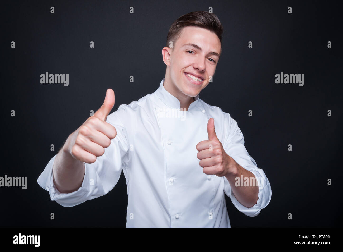 Happy successful cook looking confident and indicate double like sign ...