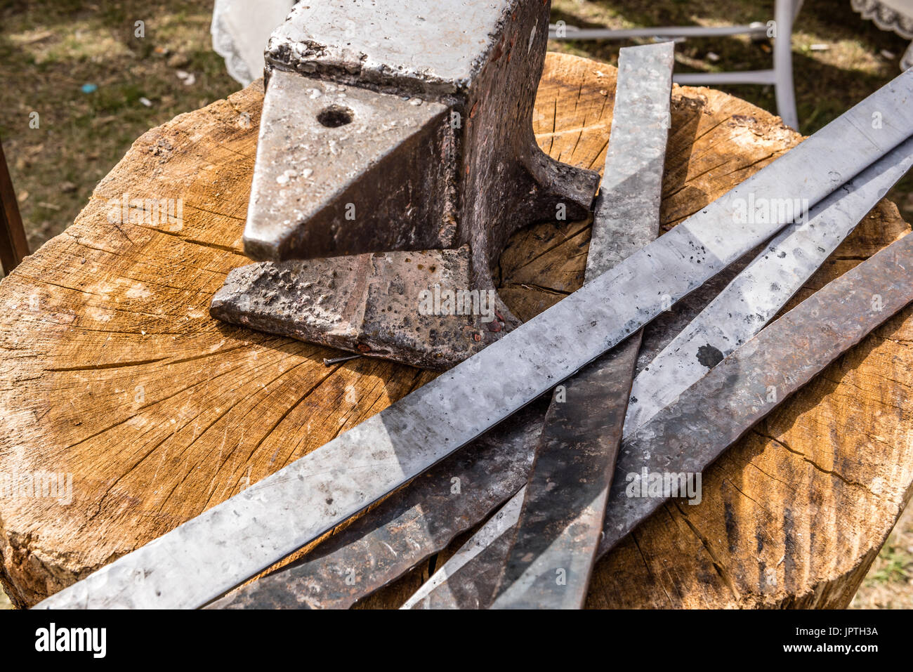 Anvil and iron plates on a wooden table Stock Photo - Alamy