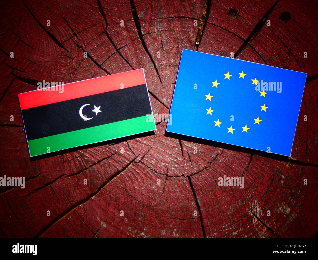 Libyan flag with EU flag on a tree stump isolated Stock Photo - Alamy