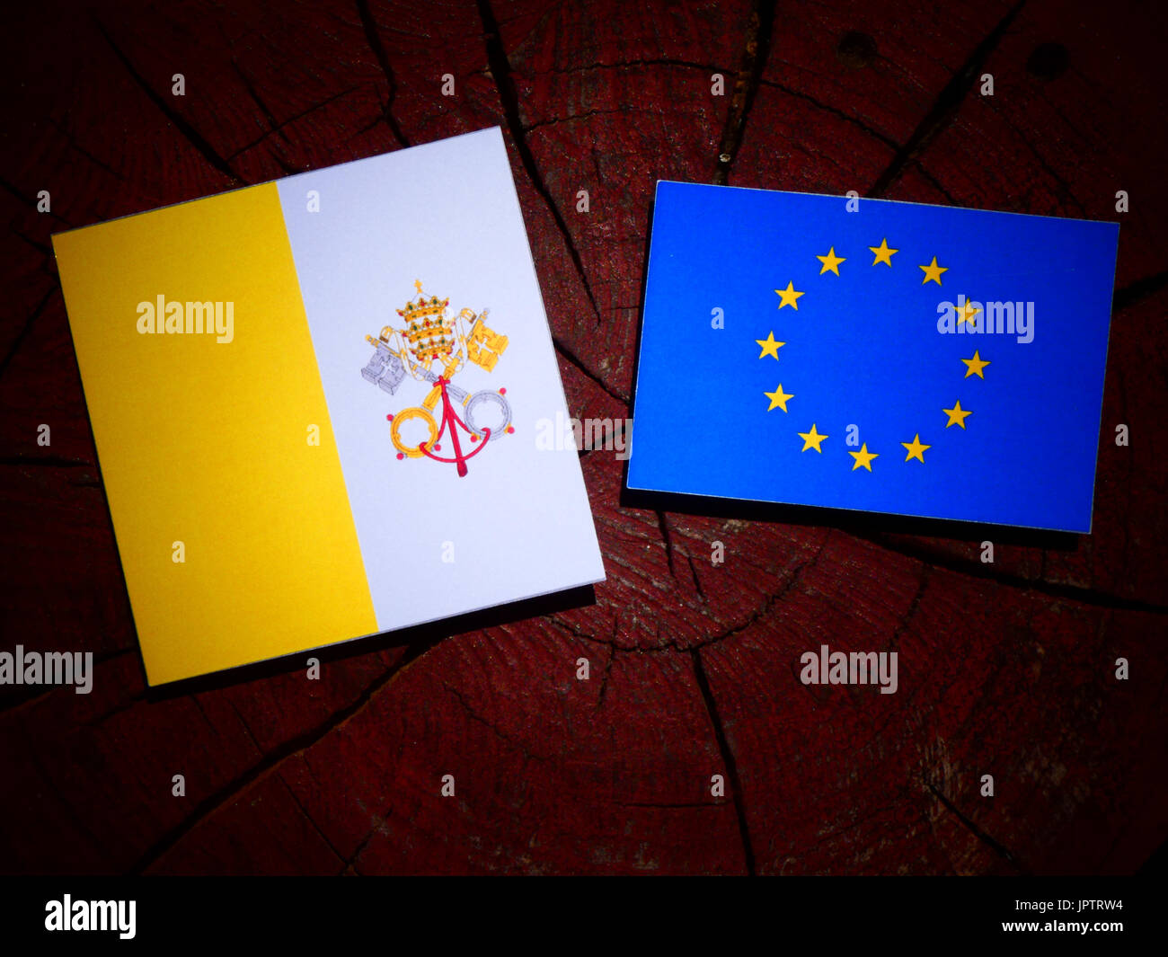 Vatican flag with EU flag on a tree stump isolated Stock Photo - Alamy