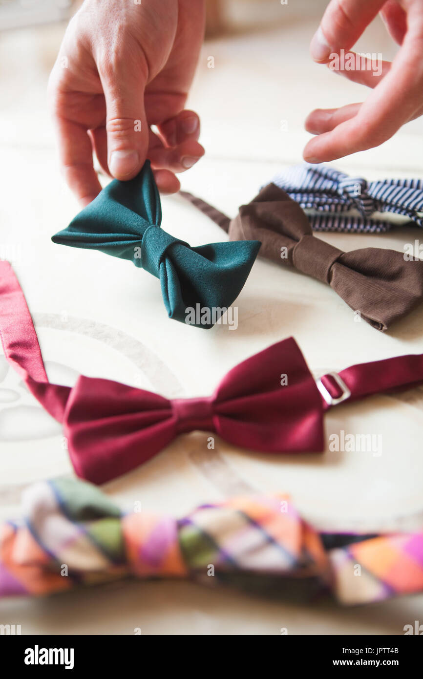 The male hand choosing hand made bow ties Stock Photo - Alamy