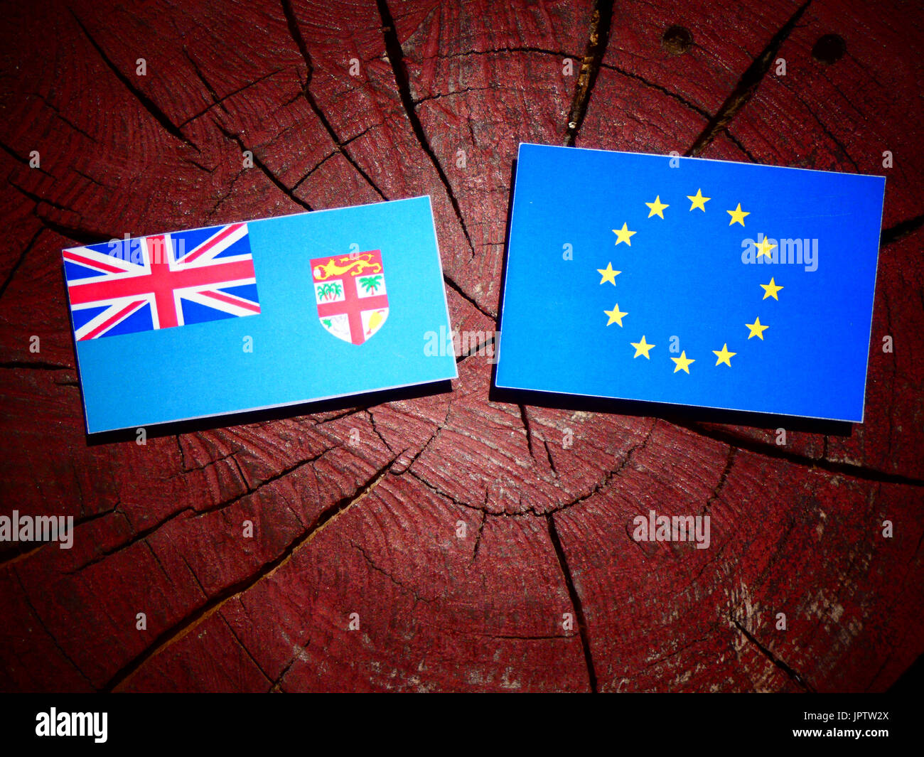 Fijian flag with EU flag on a tree stump isolated Stock Photo - Alamy
