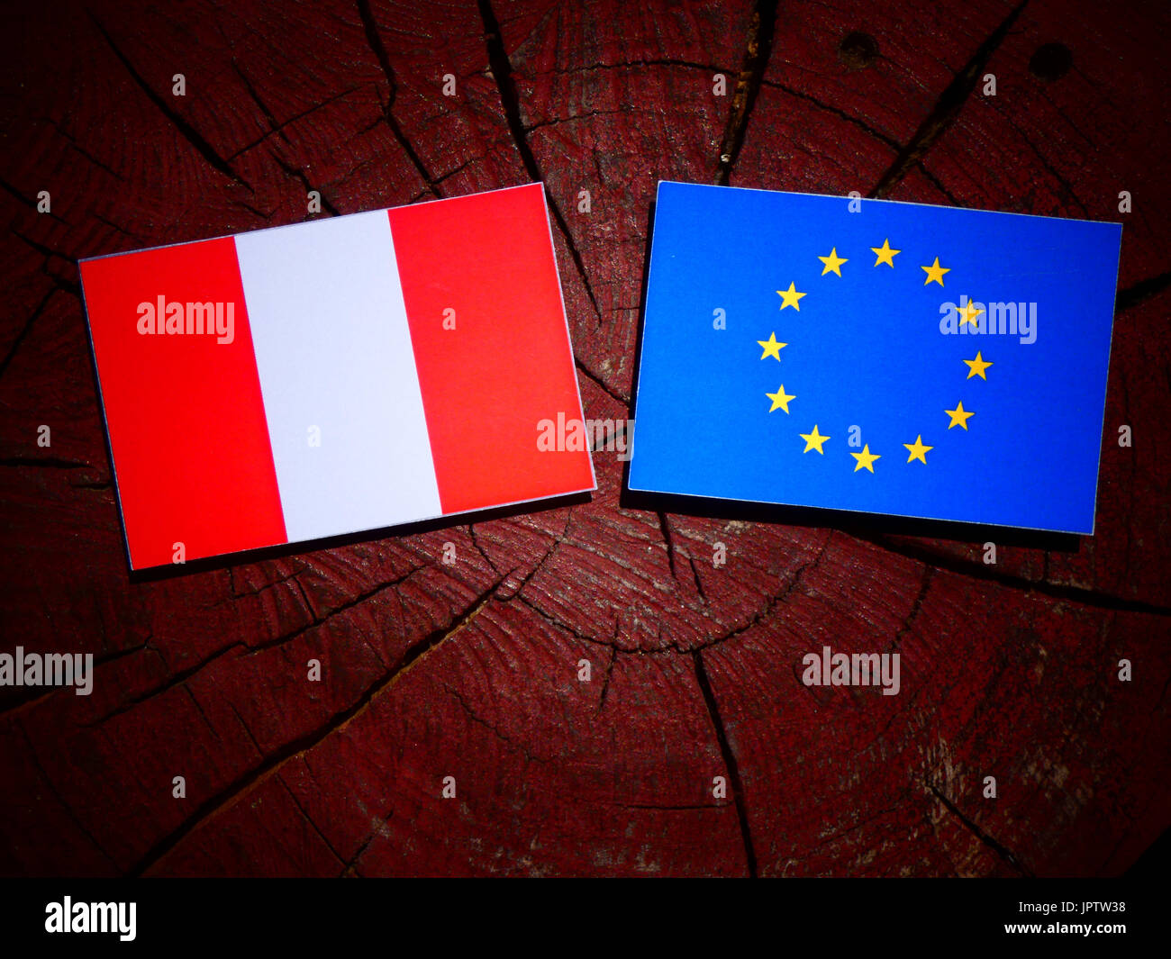 Peruvian flag with EU flag on a tree stump isolated Stock Photo - Alamy