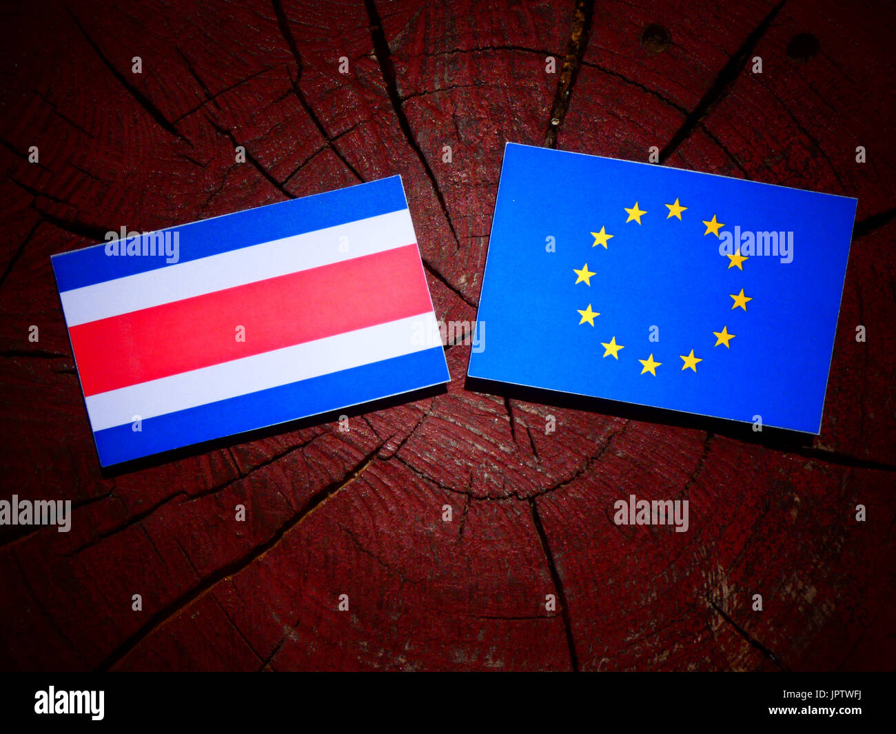 Costa Rican flag with EU flag on a tree stump isolated Stock Photo - Alamy