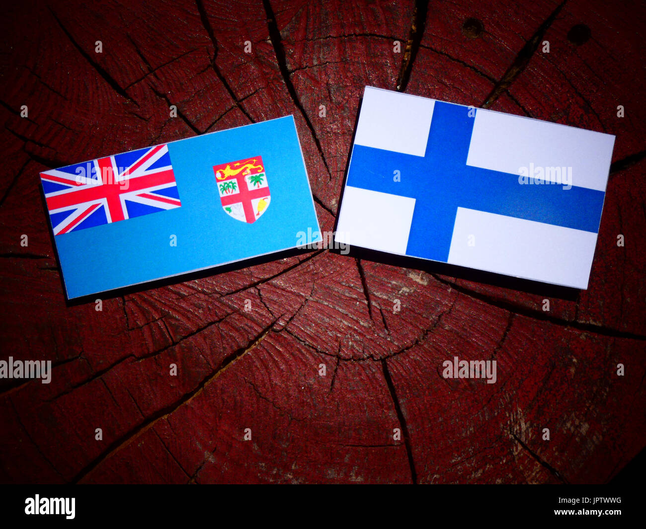 Fijian flag with Finnish flag on a tree stump isolated Stock Photo - Alamy