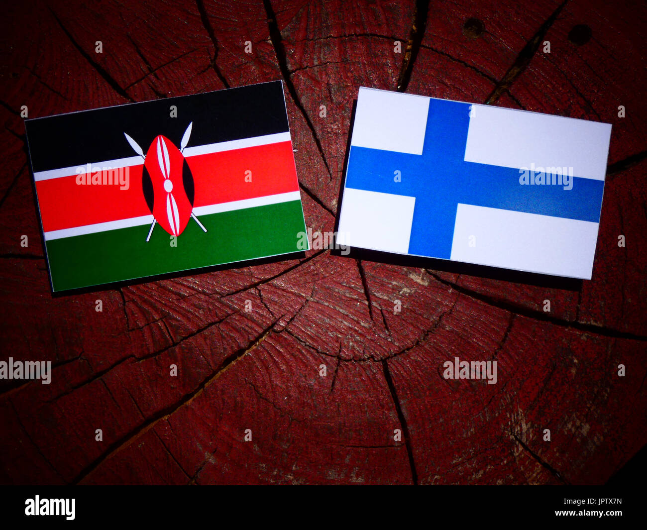 Kenyan flag with Finnish flag on a tree stump isolated Stock Photo - Alamy